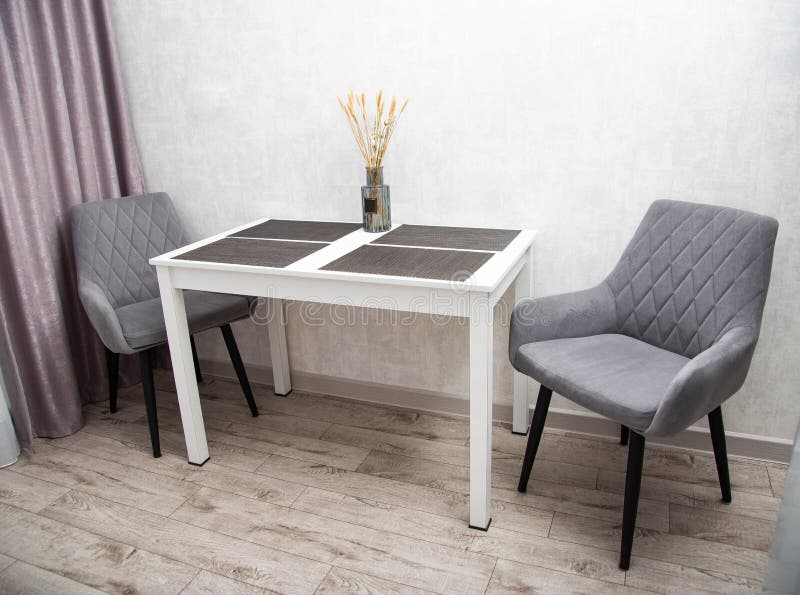 Modern Interior of a Dining Table in the Kitchen and Comfortable Chairs ...