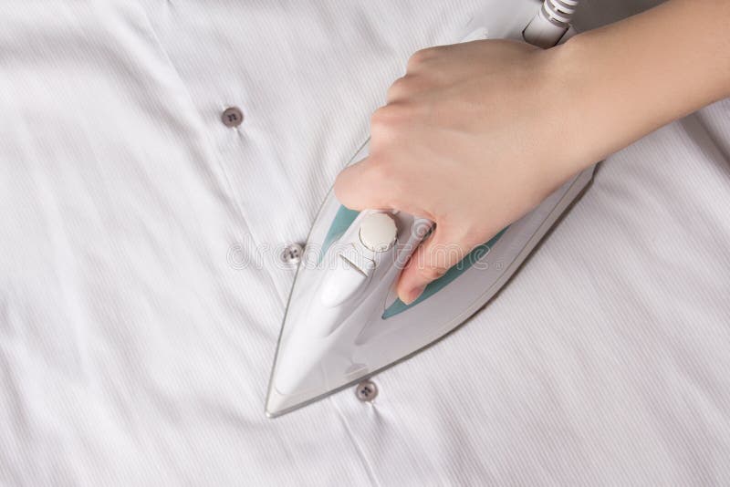 Modern Iron in Female Hand Ironing Cotton Shirt Stock Image - Image of ...