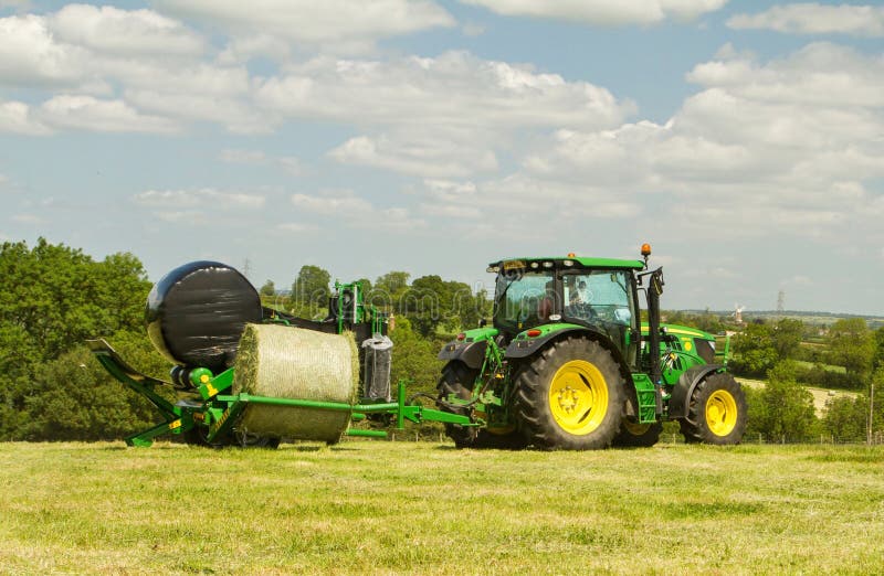 Modern John Deere Green Tractor with Round Bale Wrapper Editorial ...