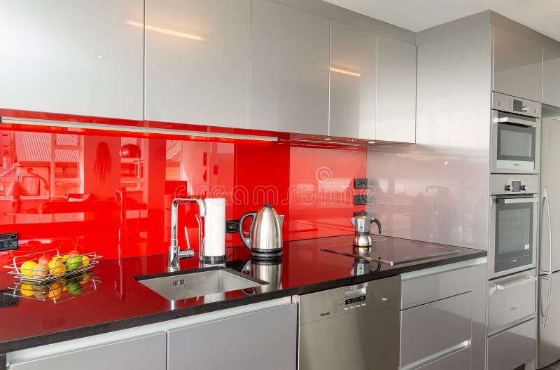 Modern Kitchen in an Apartment with a Red Backsplash and Quality ...