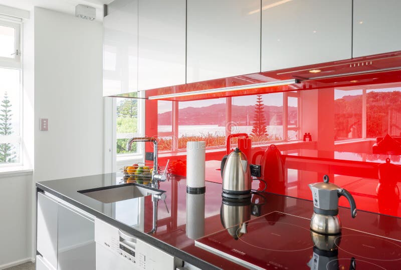 Modern Kitchen in an Apartment with a Red Backsplash and Quality ...