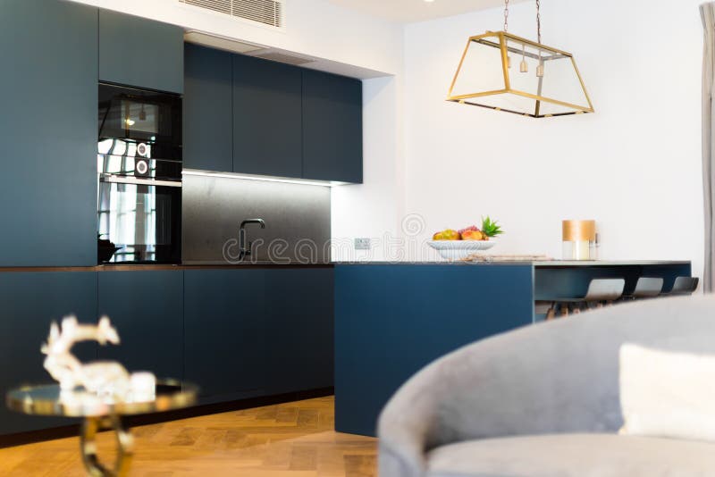 Modern Kitchen Behind a Blurry Sofa Stock Photo - Image of indoors ...