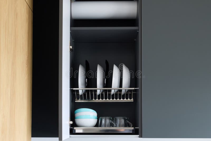 A Modern Kitchen Cabinet Displays an Array of White Plates and Elegant ...