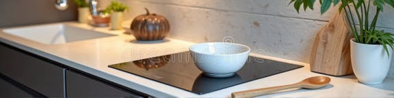 Modern Kitchen Counter with White Bowl and Induction Stove Stock Photo ...