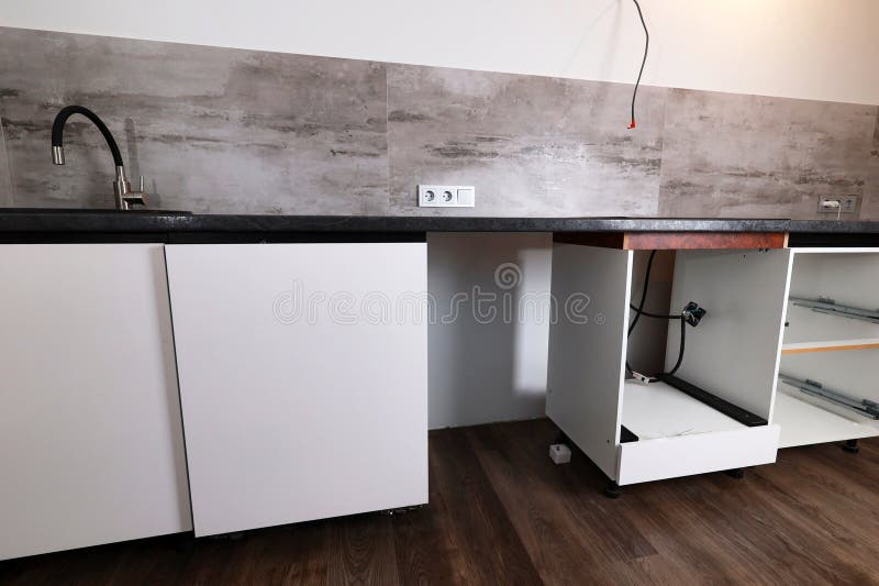 Modern Kitchen. Installing White Cabinets in the Kitchen during ...