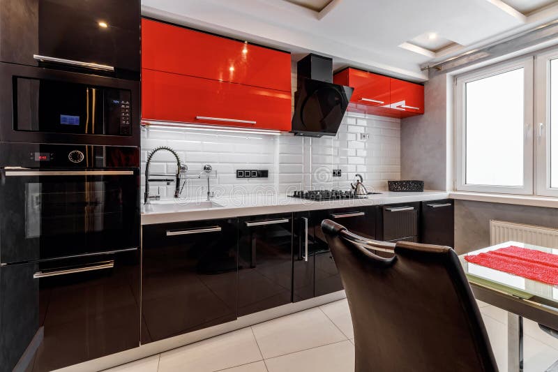 Modern Kitchen Interior with Red and Black Cabinets and White Ceramic ...