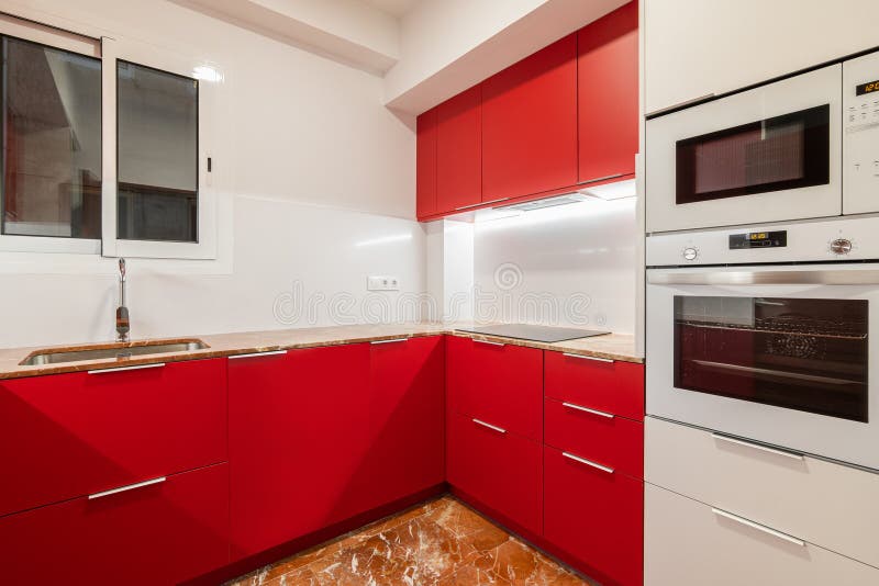 A Modern Kitchen with Red Cabinets and White Appliances Stock Image ...