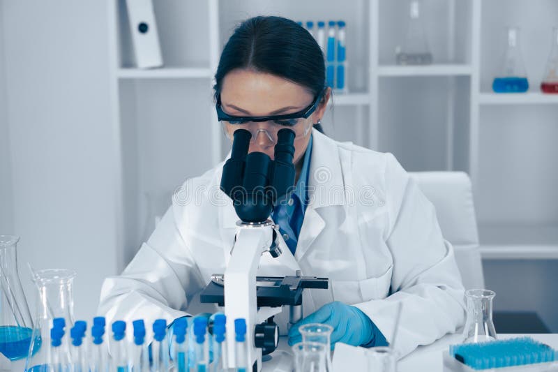 A Scientist is Diligently Analyzing Various Samples Under a Highpowered ...