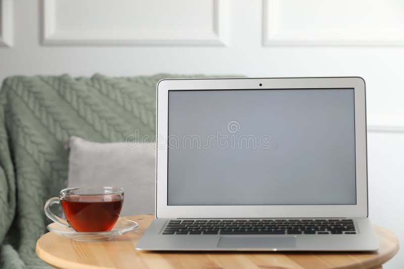 Modern Laptop and Cup of Tea on Wooden Table Indoors Stock Image ...