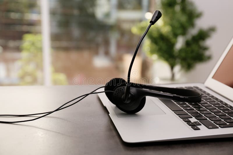 Modern Laptop and Headset on Table Indoors Stock Photo - Image of help ...