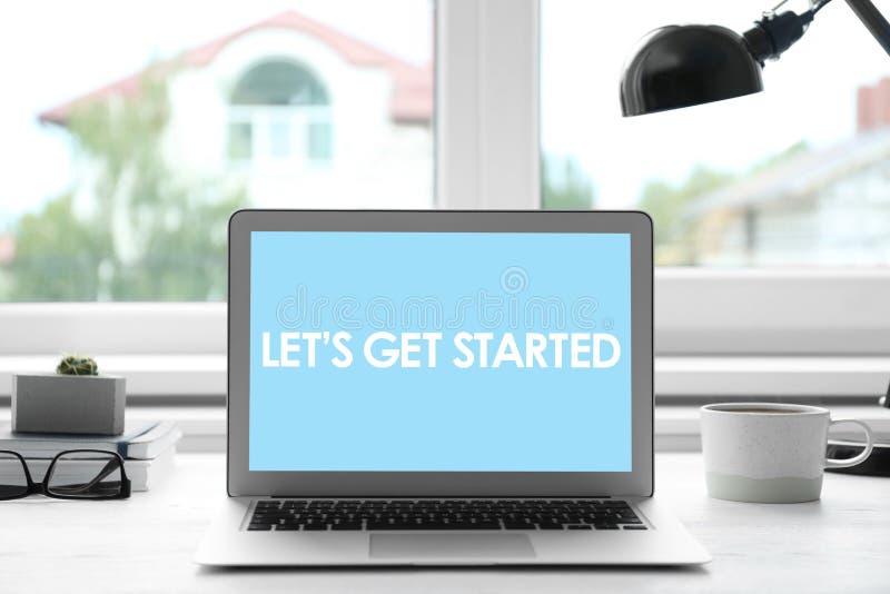 Modern Laptop with Phrase Let`s Get Started on Screen in Office Stock ...