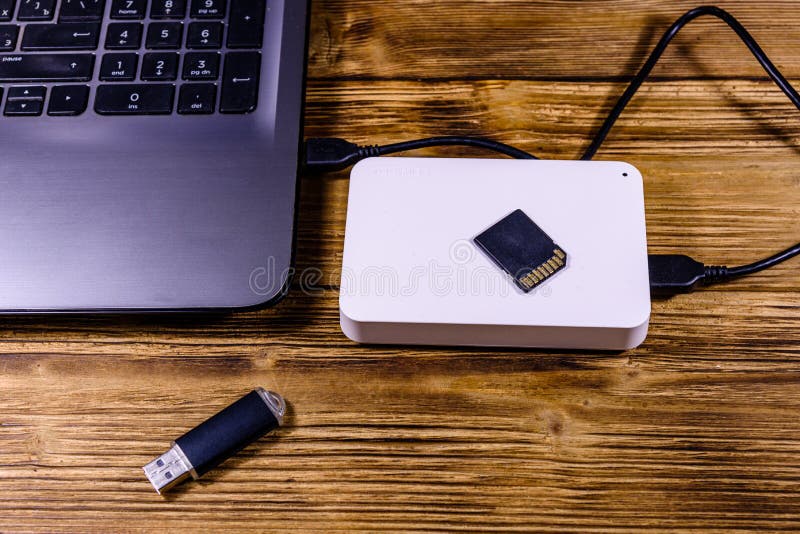 Modern Laptop, Sd Card, Flash Memory Card and Ssd Hard Drive on a ...