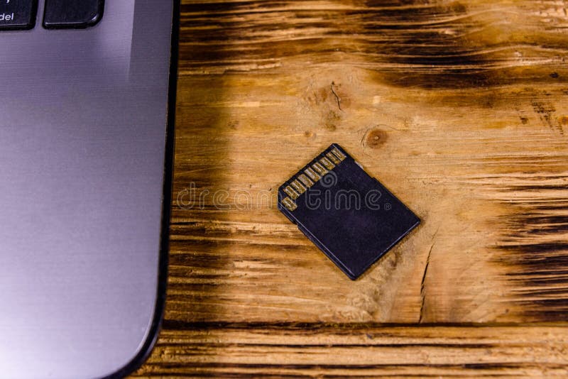 Modern Laptop and Sd Memory Card on a Wooden Desk Stock Photo - Image ...