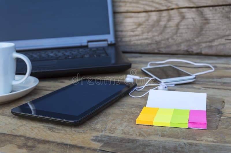 Modern Laptop, Tablet, Mobile Phone and Sticky Notes on the Table ...
