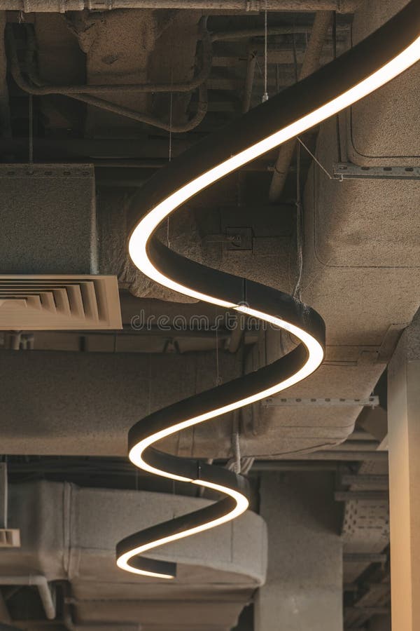 Modern LED Lighting by Curved Lamp in Industrial Interior. Ceiling in ...