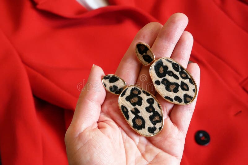 Modern Leopard Earring in Hand, Woman Makes Modern Outfit Stock Image ...