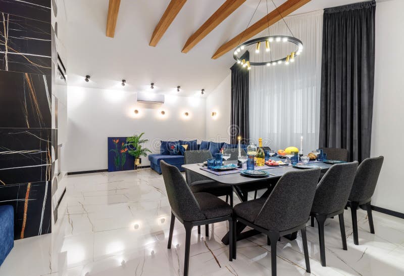 A Modern Living Room with a Blue Sofa and a Fixed Table. Ceiling with ...