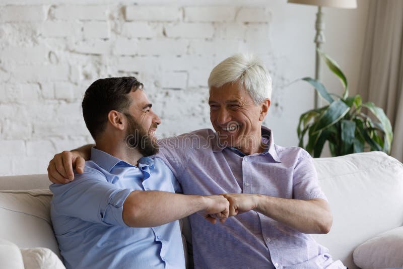 Older Father His Young Adult Son Fist Bumping Express Respect Stock