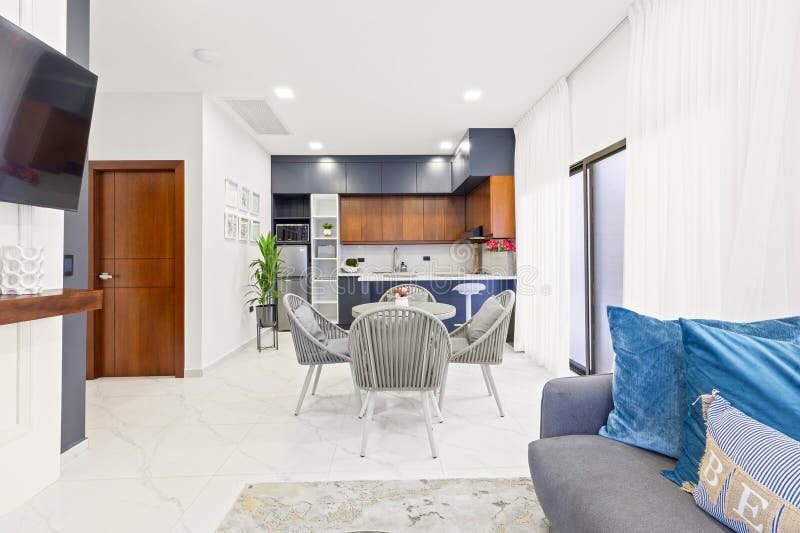 Modern Living Room with a Sofa and Wall-mounted TV Stock Image - Image ...