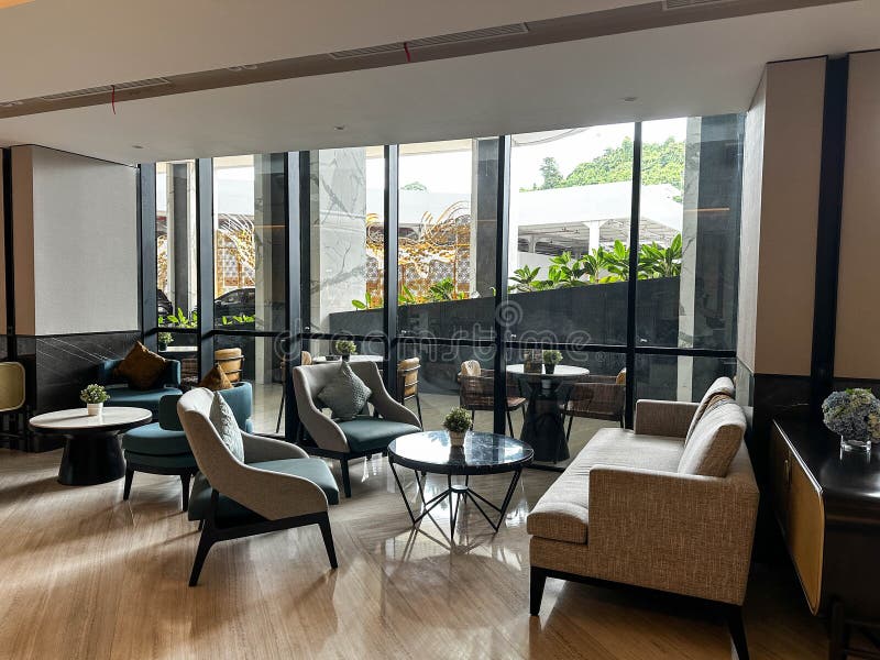Modern Lounge Area with Comfortable Seating and Natural Light in a City ...