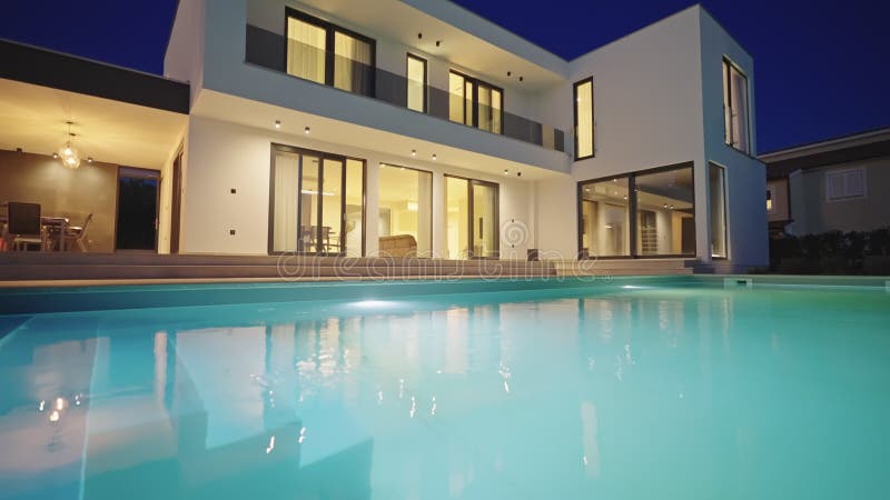 Modern Luxury Villa Illuminated at Night, Featuring a Serene Pool in ...