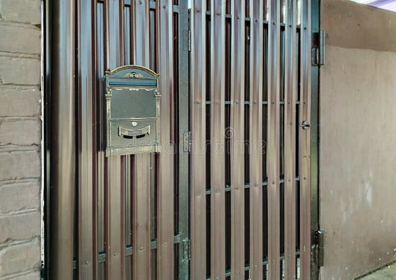Modern Mailbox on a New Metal Gate Made of Siding and Profiles Stock ...