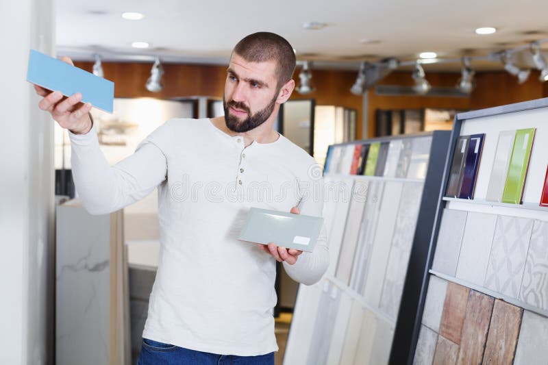 Modern Man Standing with Sample of Ceramic Tile Stock Photo - Image of ...