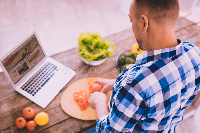 Modern Man Watching a Video How To Cook a Delicious Dinner Stock Image ...