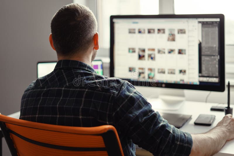 Modern Man Working Remotely on a Computer from Home Office Stock Photo ...