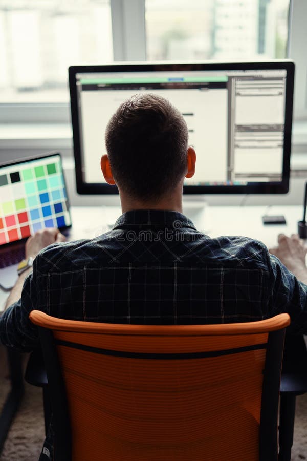 Modern Man Working Remotely on a Computer from Home Office Stock Photo ...
