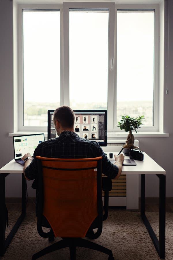 Modern Man Working Remotely on a Computer from Home Office Stock Photo ...