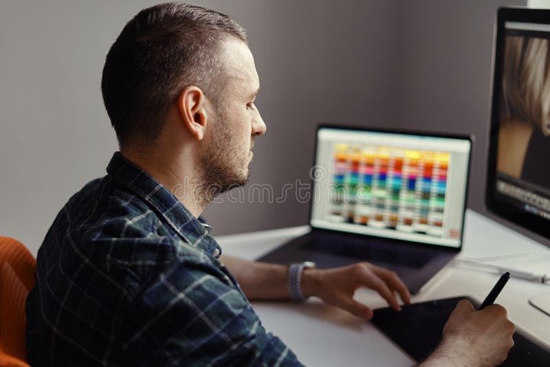 Modern Man Working Remotely on a Computer from Home Office Stock Photo ...