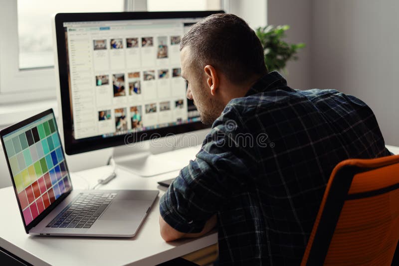 Modern Man Working Remotely on a Computer from Home Office Stock Image ...