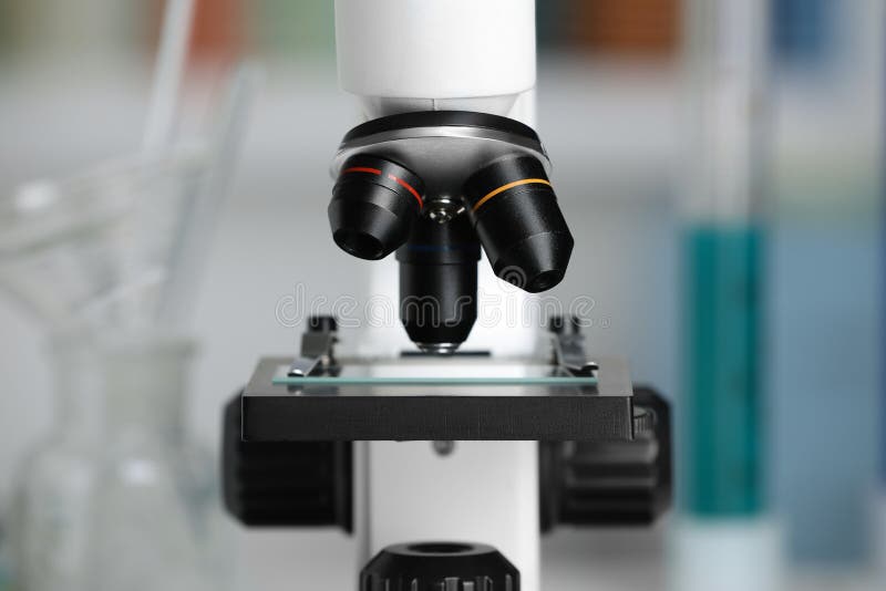 Modern Medical Microscope with Glass Slide on Blurred Background ...