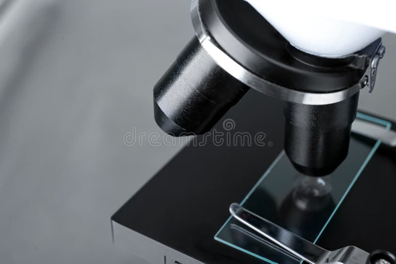 Modern Medical Microscope with Glass Slide on Grey Background, Closeup ...