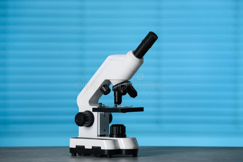 Modern Medical Microscope on Grey Table Indoors Stock Photo - Image of ...