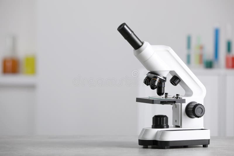 Modern Medical Microscope on Grey Table in Laboratory, Space for Text ...
