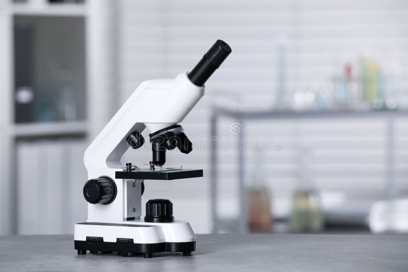Modern Medical Microscope on Grey Table in Laboratory, Space for Text ...