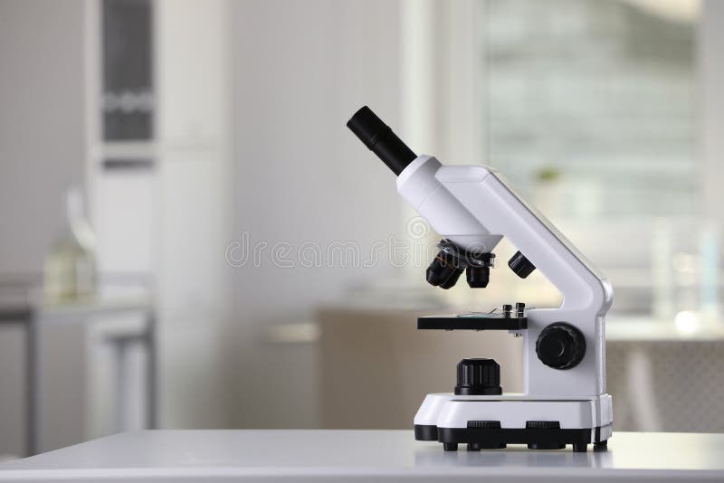 Modern Medical Microscope on White Table in Laboratory, Space for Text ...
