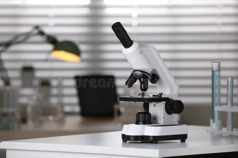 Modern Medical Microscope on White Table in Laboratory, Space for Text ...