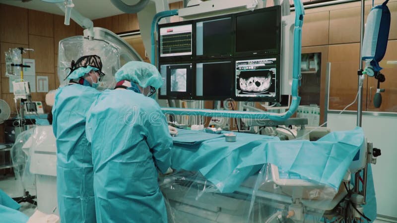 Operating Room in Which Doctors Perform Surgery Looking into Monitors ...