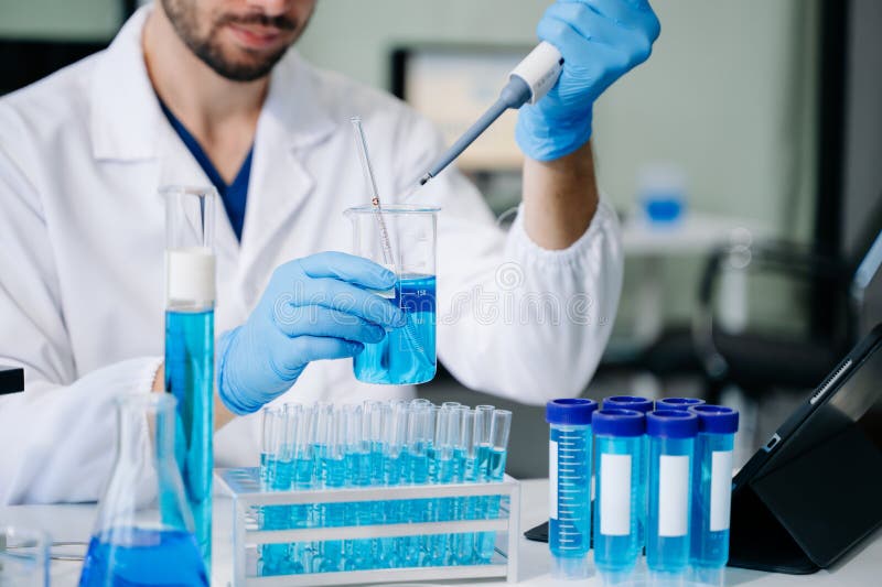 Male Scientist Working with Micro Pipettes Analyzing Biochemical ...