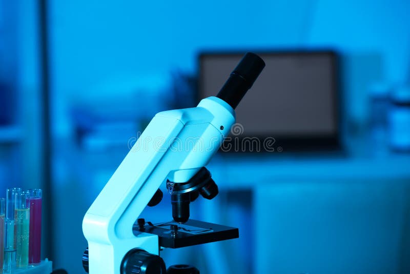 Modern Microscope with Glass Slide in Laboratory, Toned in Blue. Space ...