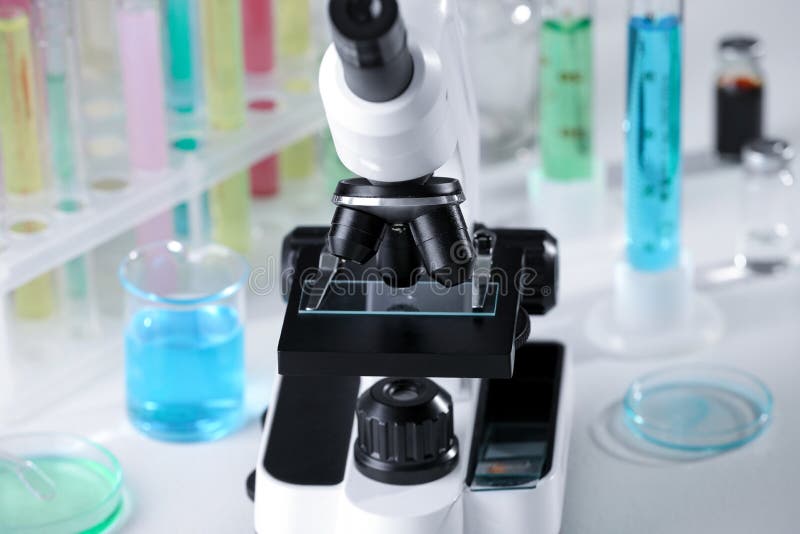 Modern Microscope with Glass Slide on White Table in Laboratory ...