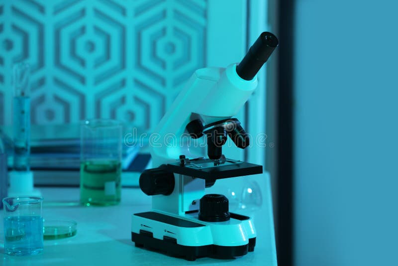 Modern Microscope with Glass Slide on White Table in Laboratory, Toned ...