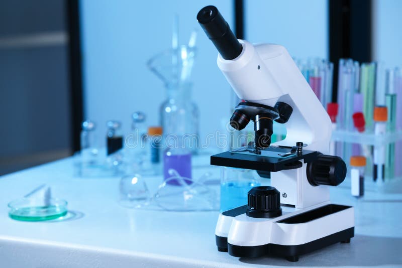 Modern Microscope with Glass Slide on White Table in Laboratory. Space ...
