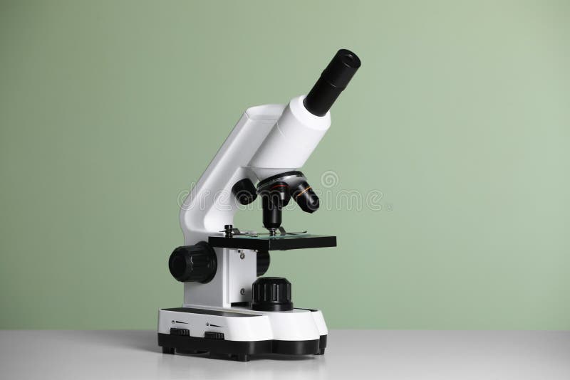 Modern Microscope on Table Against Green Background Stock Image - Image ...