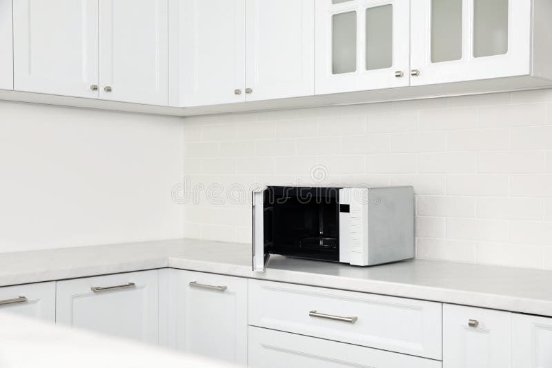 Modern Microwave Oven on Countertop in Kitchen Stock Image - Image of ...