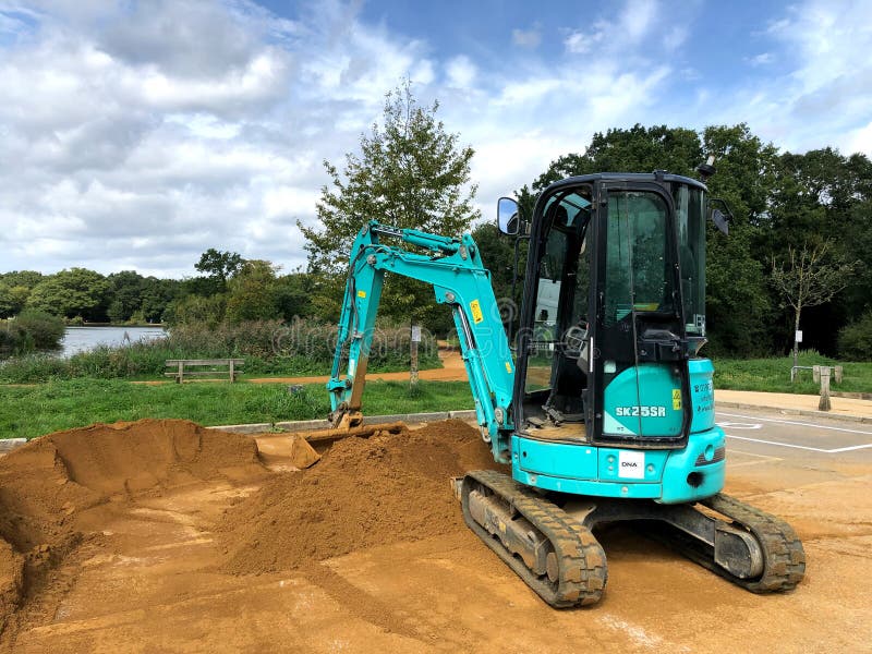 The Modern Mini Blue Excavator Performs Excavation Work Editorial Image ...