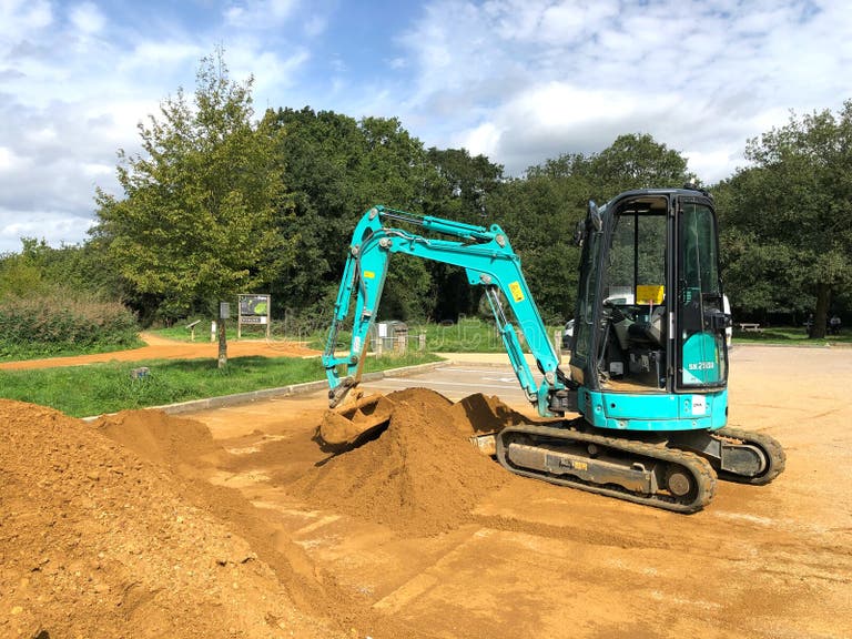 The Modern Mini Blue Excavator Performs Excavation Work Editorial Stock ...
